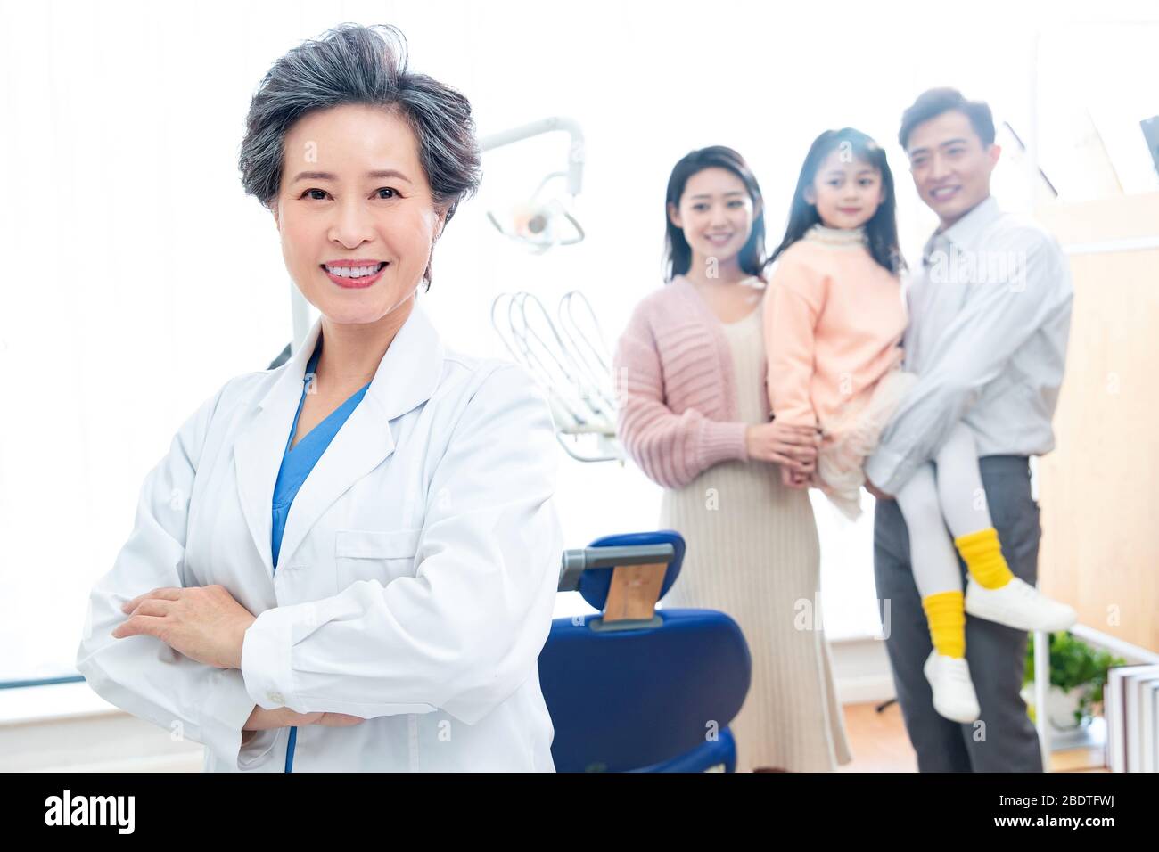 Female doctors and patients families Stock Photo - Alamy