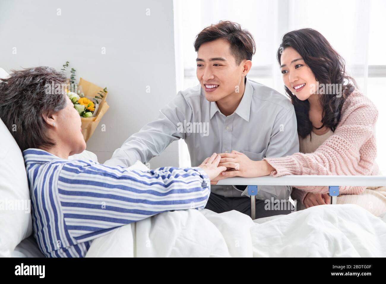 Young couples, visit sick old people Stock Photo - Alamy