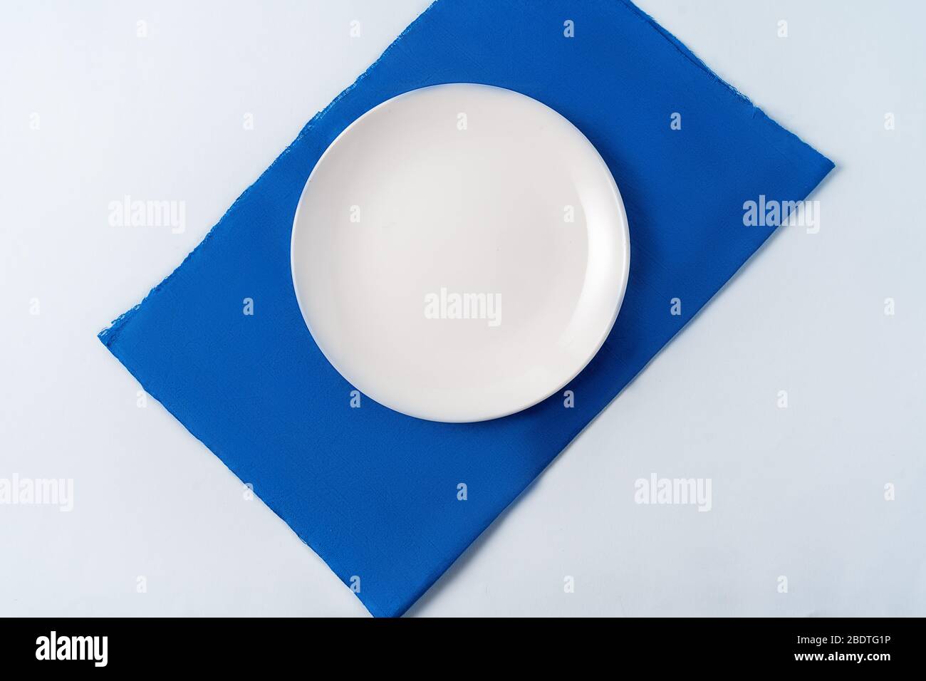 Flat lay food background with empty white plate and napkin, over white ...