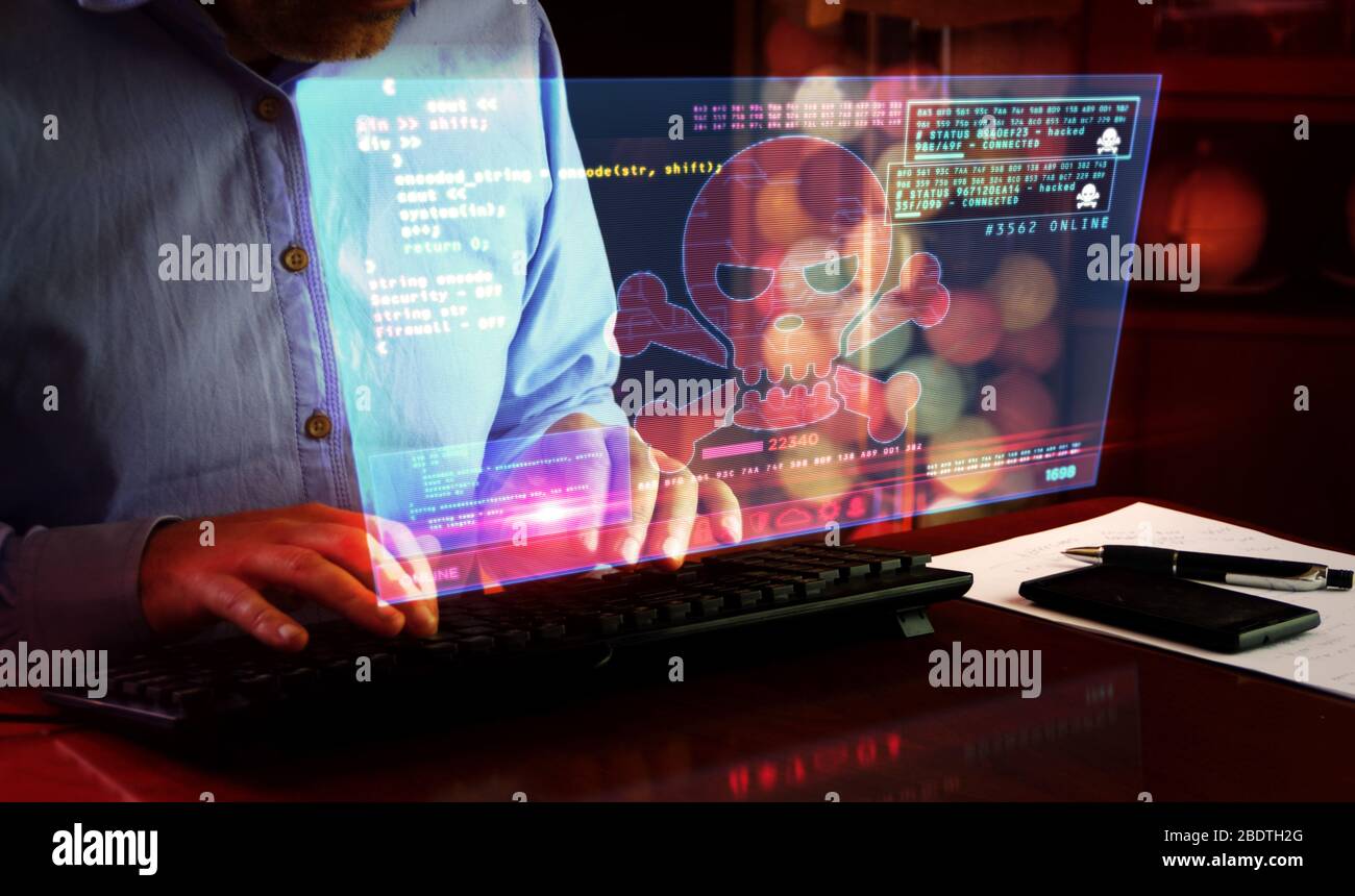 Hacker typing on the keyboard and breaks computer security on virtual hologram screen on desk ...