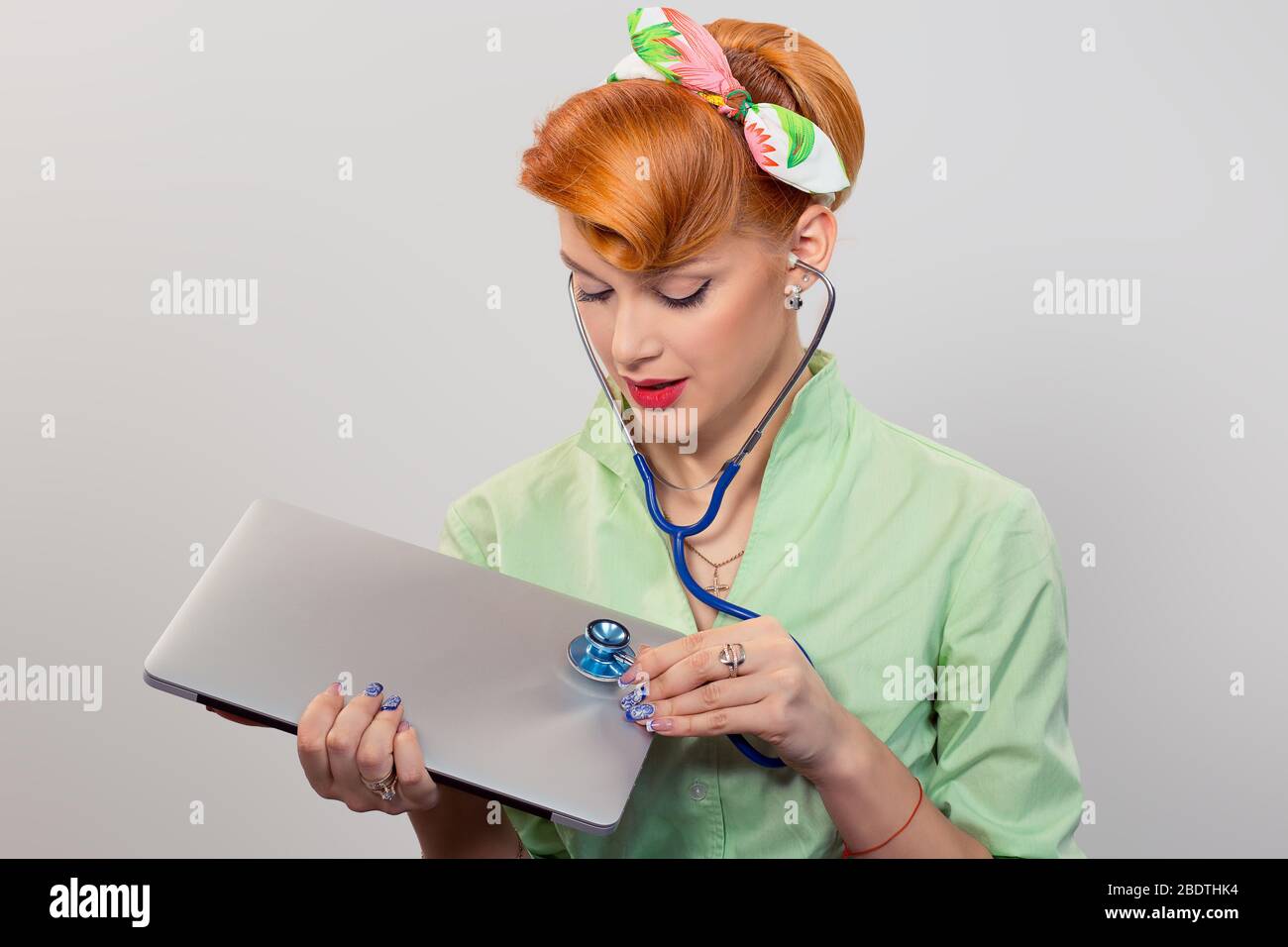 Serious Pinup Girl Listening Computer With Stethoscope Looking At Pc
