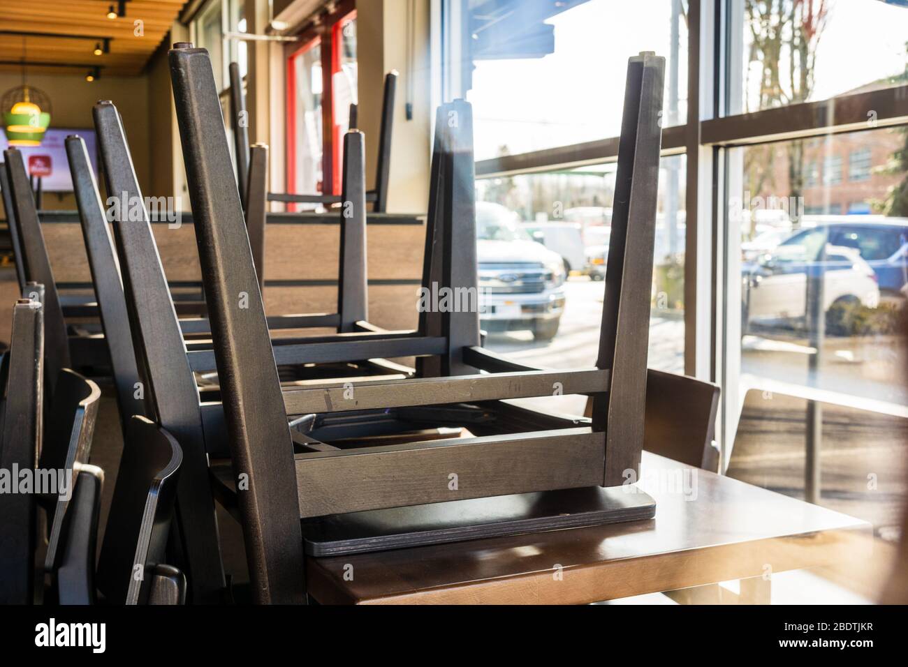 N. Vancouver - Apr 7, 2020: View through window of restaurant chairs ...