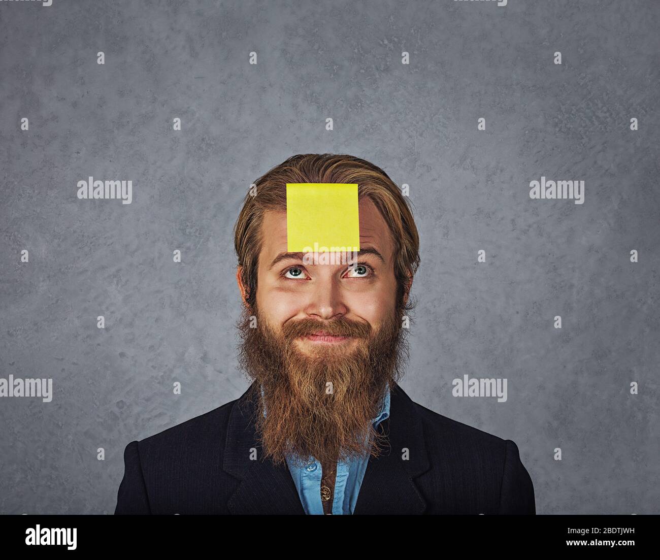 Planning. Close up bearded smiling business man looking up to the ...