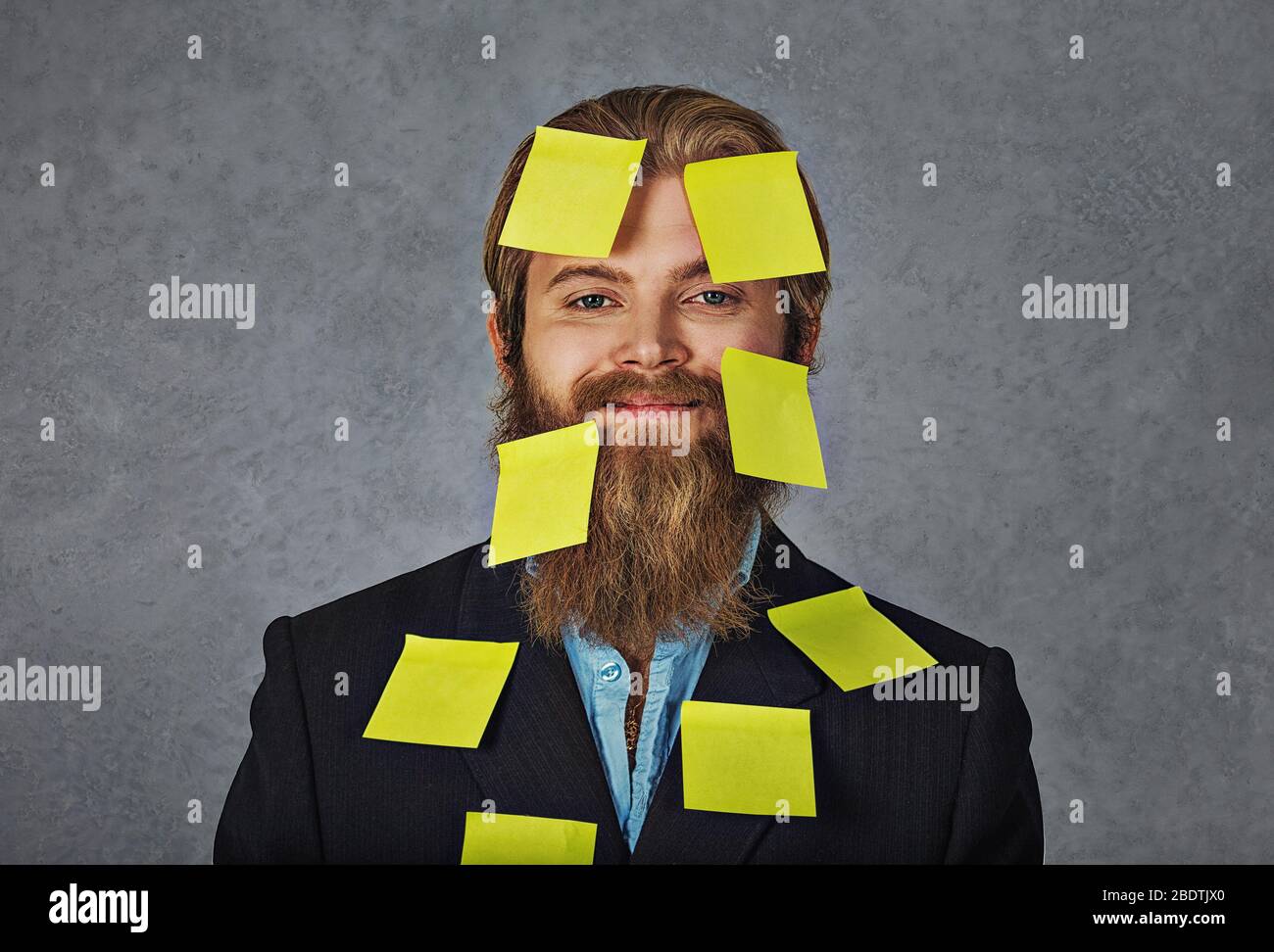 Busy. Happy smiling overwhelmed business man full of stickers, notes ...
