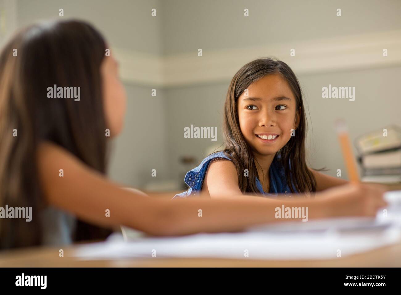 Young Girls Working On Their School Work Stock Photo - Alamy