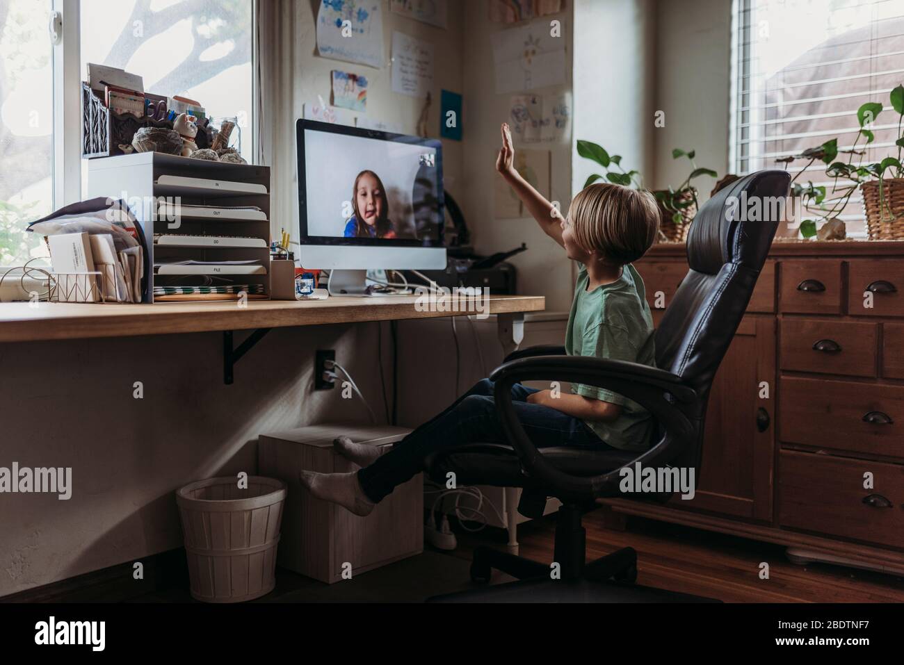 Young boy video chatting with family remotely during isolation Stock ...
