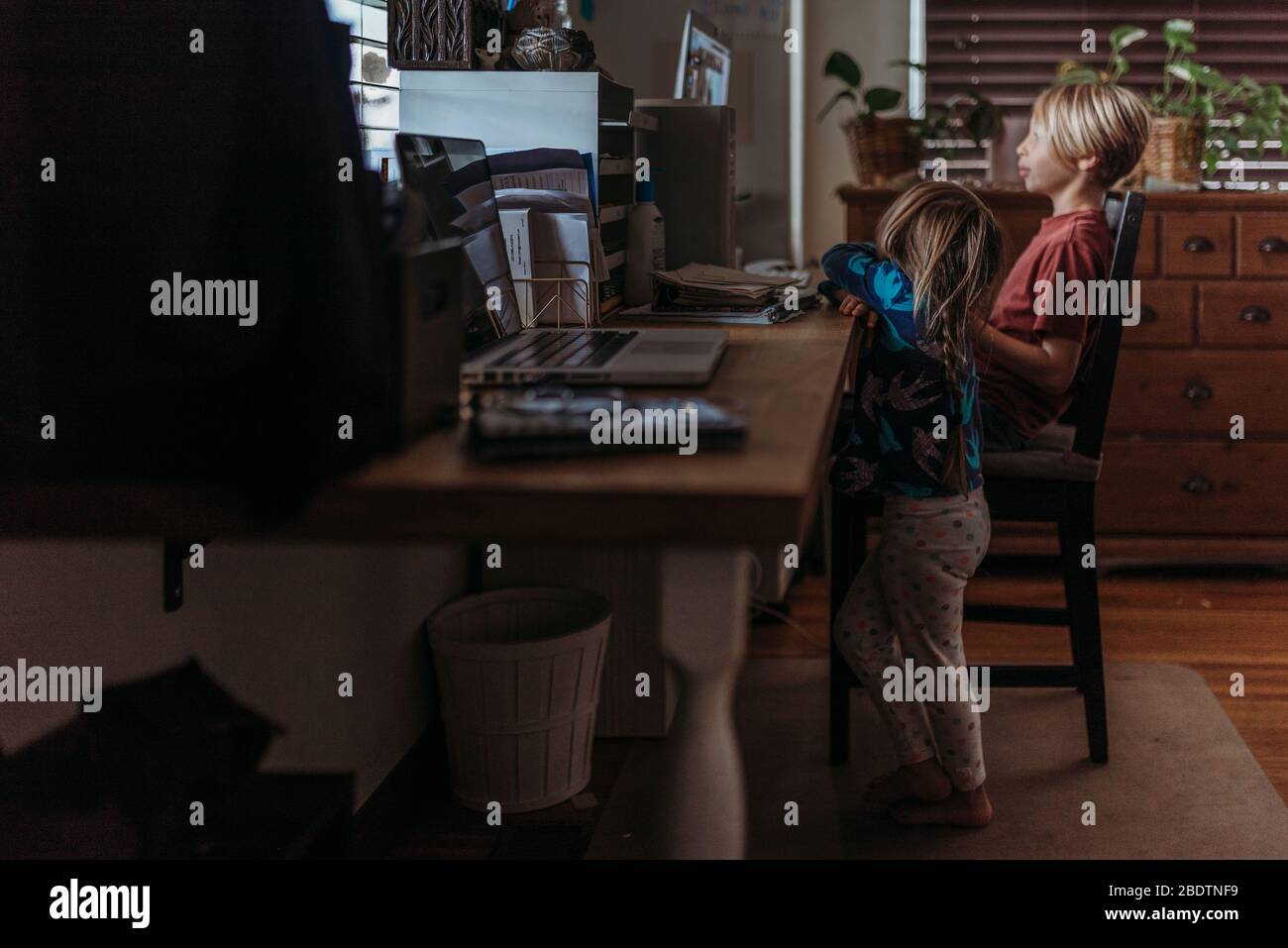 Young siblings remotely video chatting with family during isolation ...