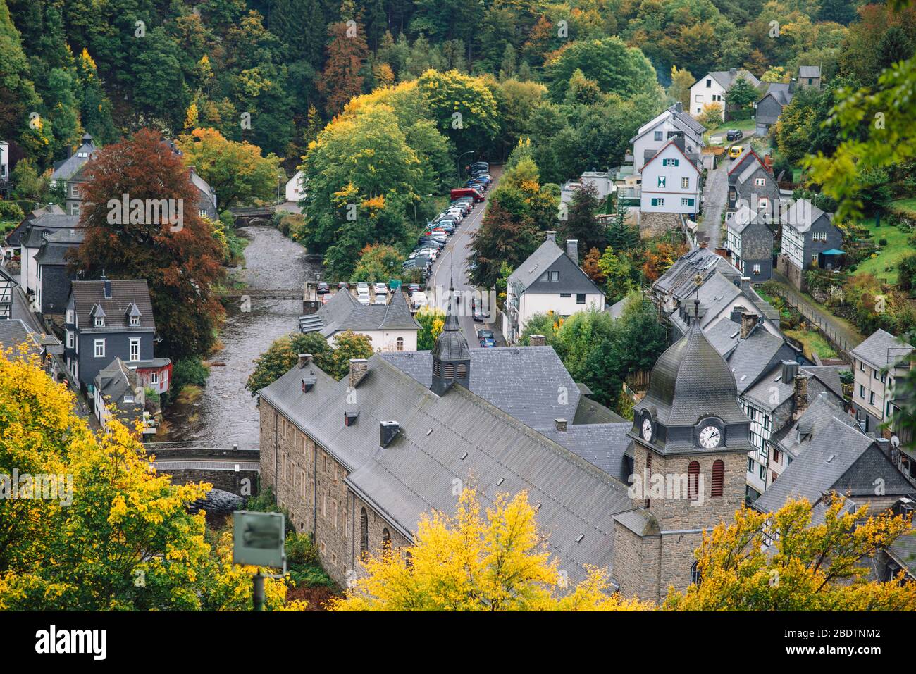 cloudy autumn panorama of the old city. Monschau, Germany. Green hills ...