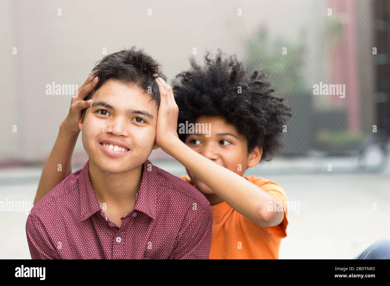 Young mixed race teenage brothers looking at the camera Stock Photo - Alamy