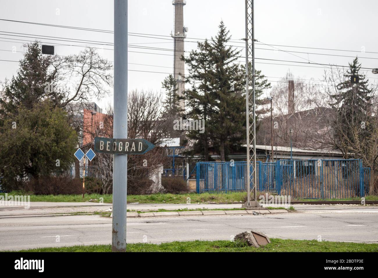 Old, rusted and in decay sign indicating the direction of Belgrade ...