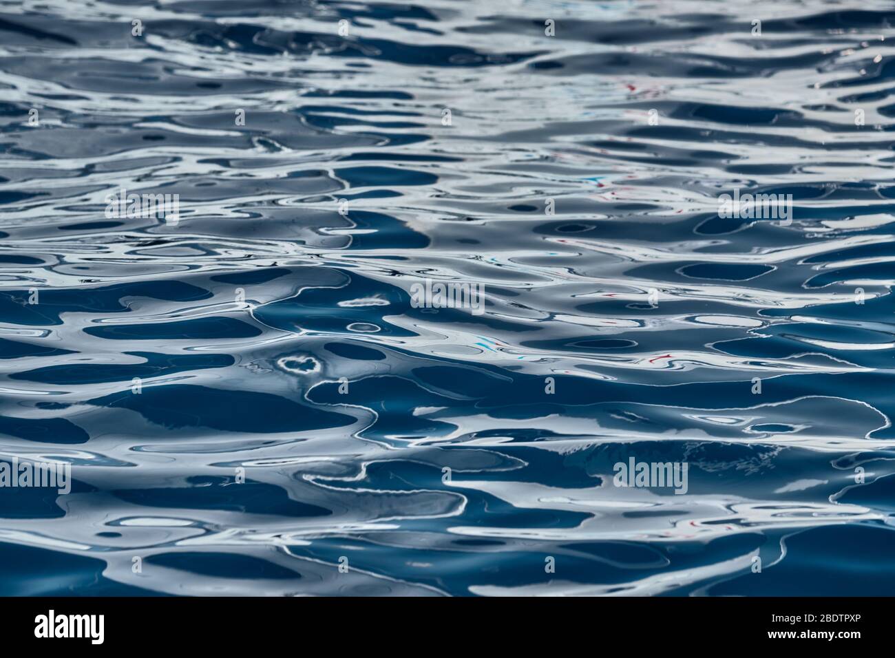 Is reflection of white sail on water, interesting texture, smooth lines ...