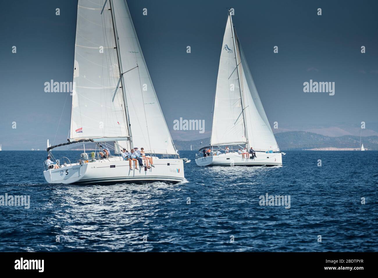 The race of sailboats, a sail regatta, reflection of sails on water ...
