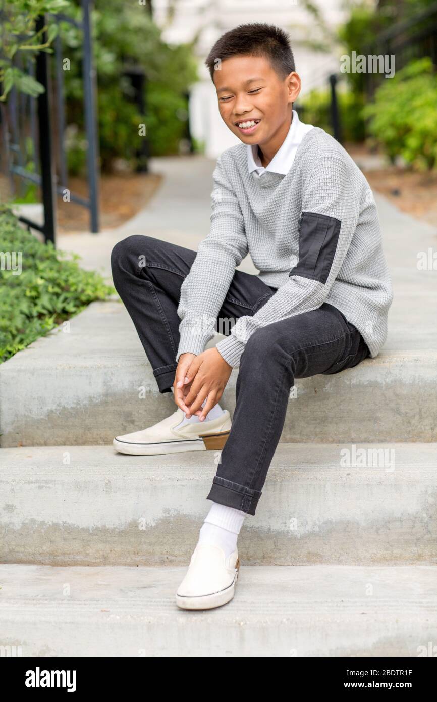 Portrait of a young Asian boy smiling outside Stock Photo - Alamy