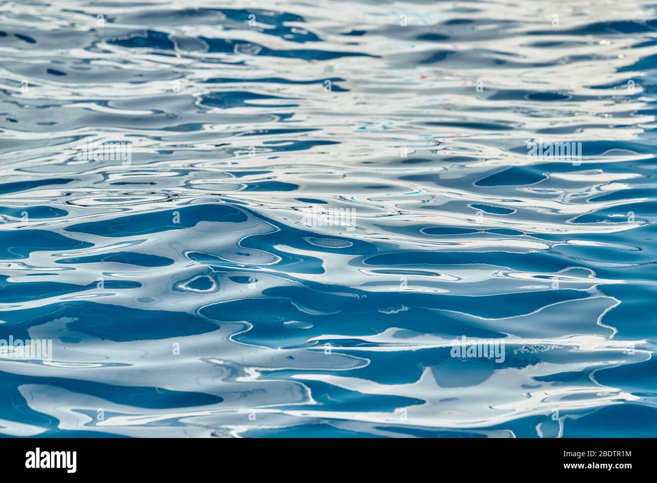Is reflection of white sail on water, interesting texture, smooth lines ...
