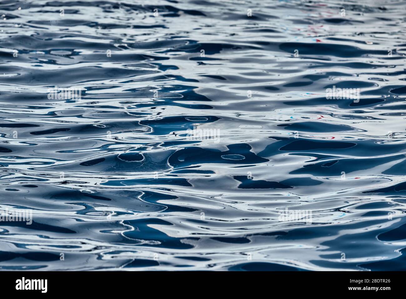 Is reflection of white sail on water, interesting texture, smooth lines ...