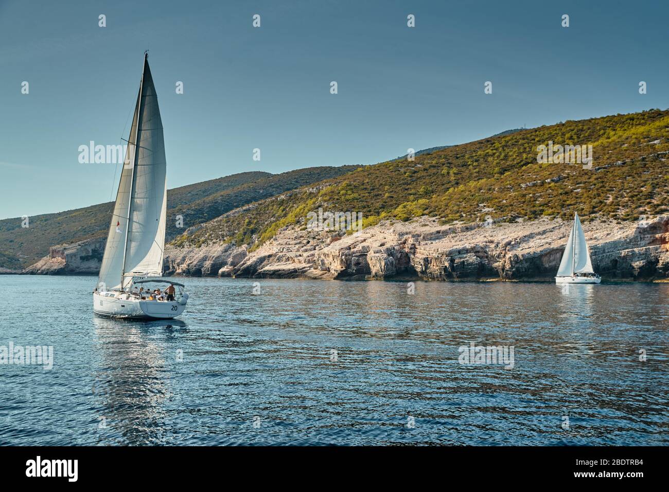 The race of sailboats, a sail regatta, reflection of sails on water ...