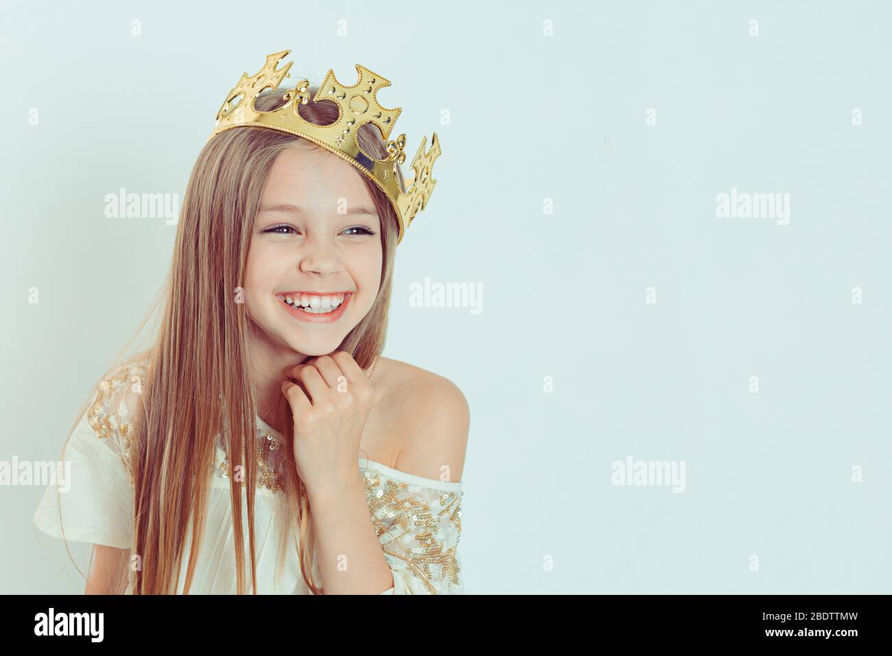 Mini Miss. Young happy girl with a cute smiling laughing wearing a ...