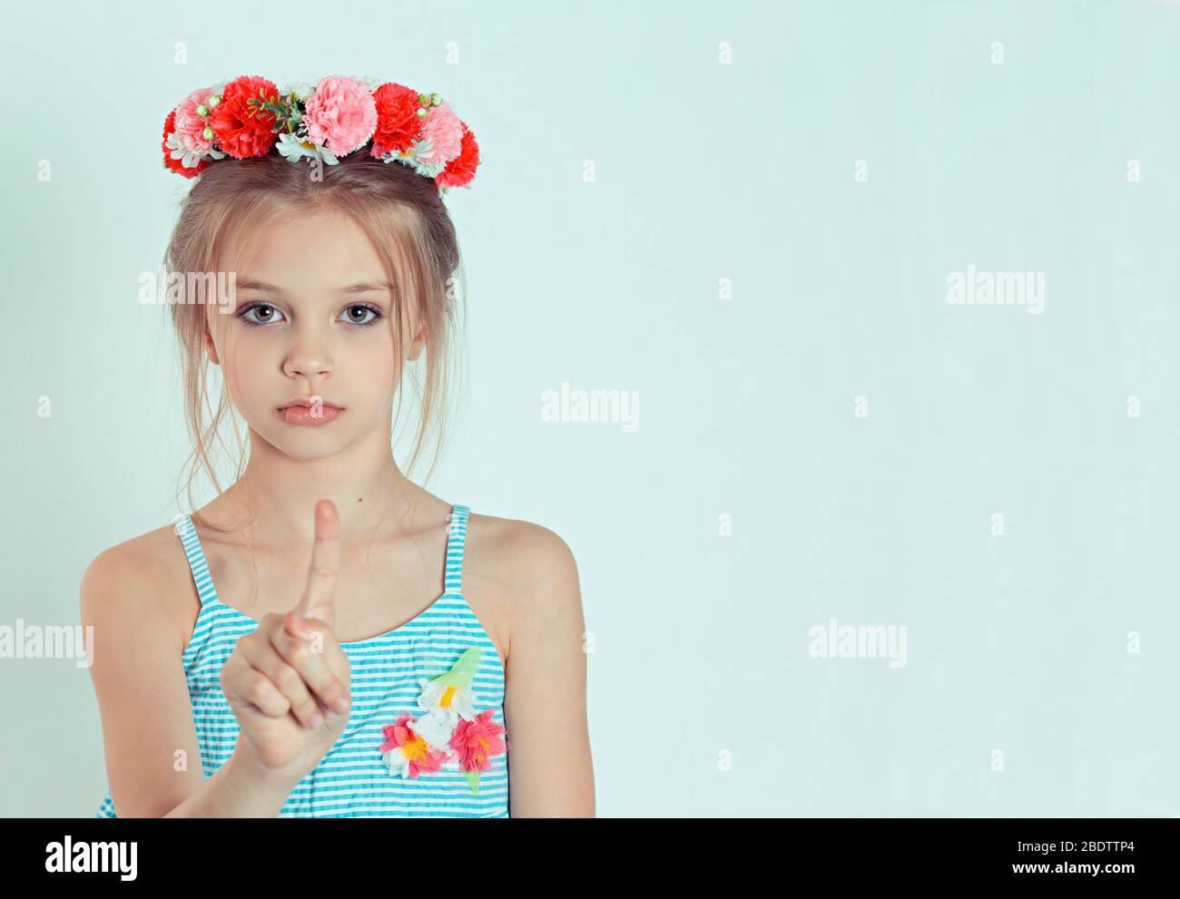 kid gesturing a no sign. portrait unhappy, serious child girl raising ...