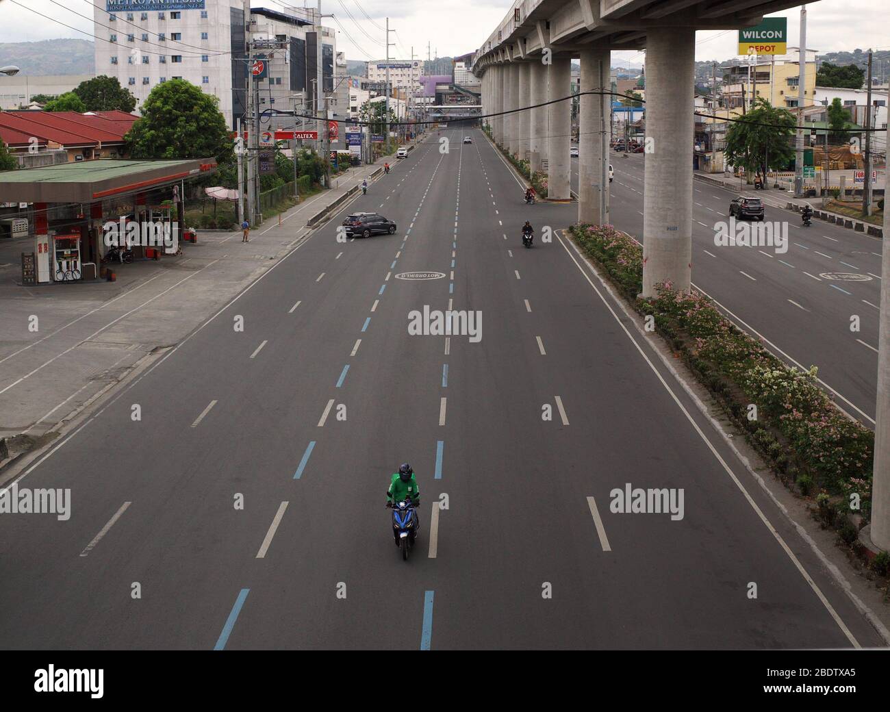April 9 2020 - A lone motorcycle rider rushes along an empty Marcos ...