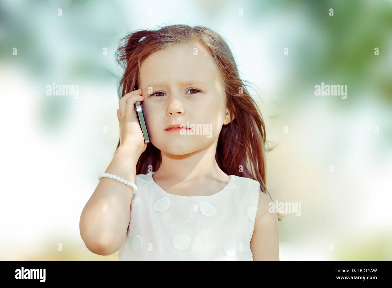 Kids & technology concept. Closeup portrait headshot beautiful upset ... Kids & technology concept. Closeup portrait headshot beautiful upset ...