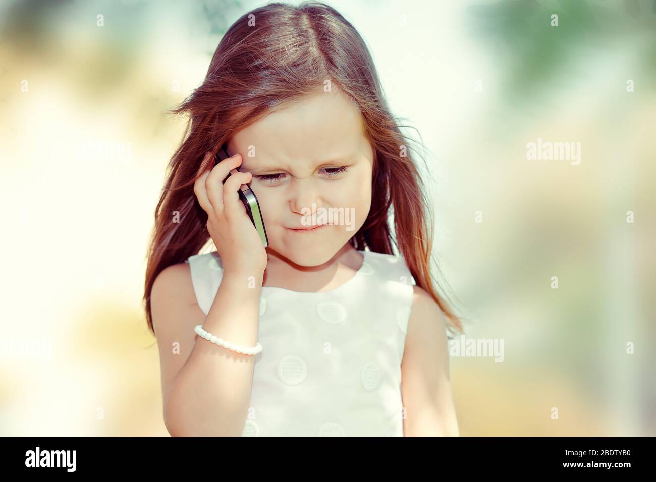 Kids & technology concept. Closeup portrait headshot of beautiful upset ... Kids & technology concept. Closeup portrait headshot of beautiful upset ...