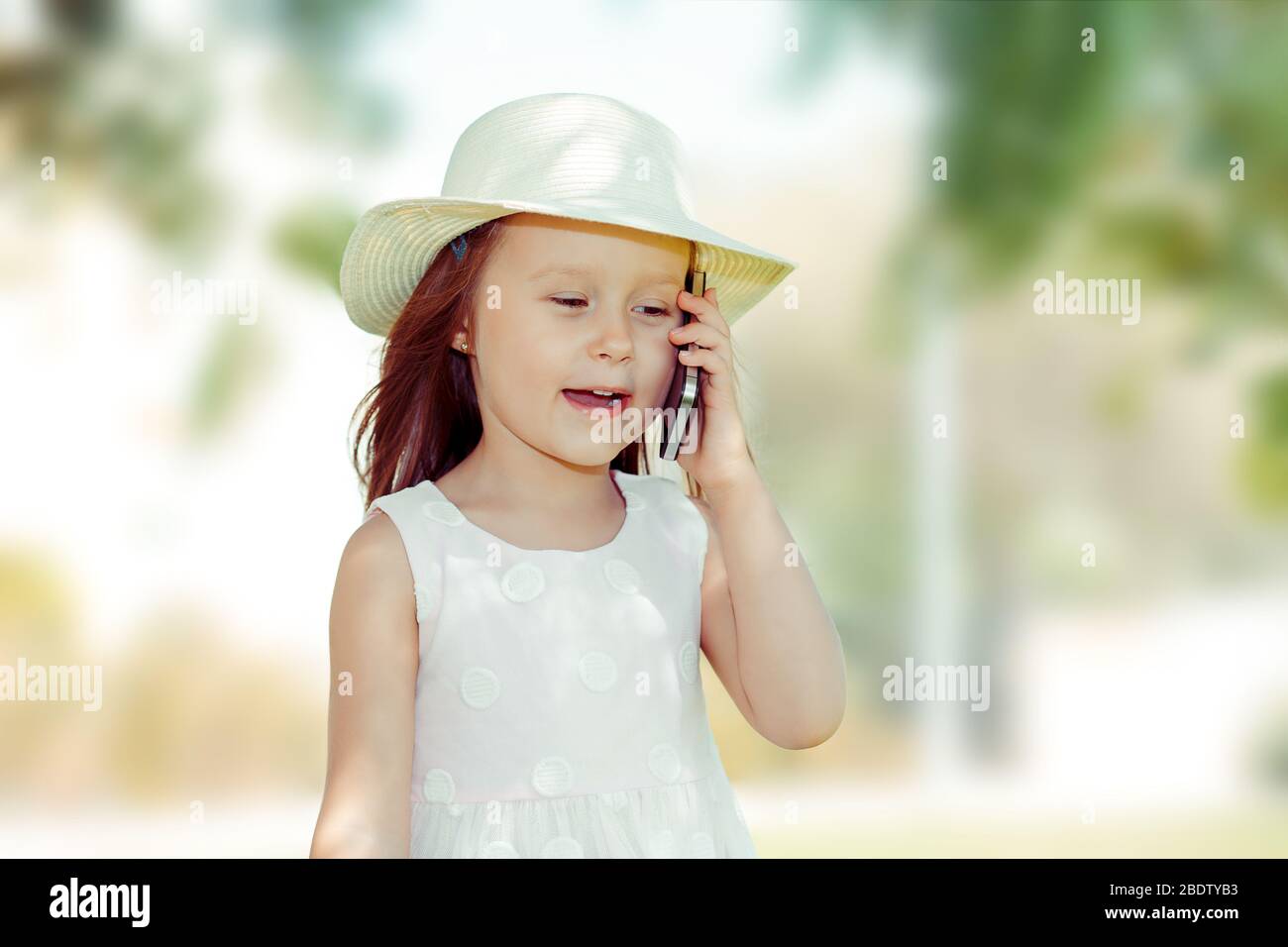 Kid with smartphone. Closeup portrait of pretty smiling funny girl kid ...