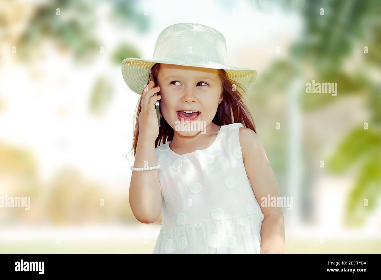 Kid with smartphone. Closeup portrait of pretty smiling funny girl kid ...