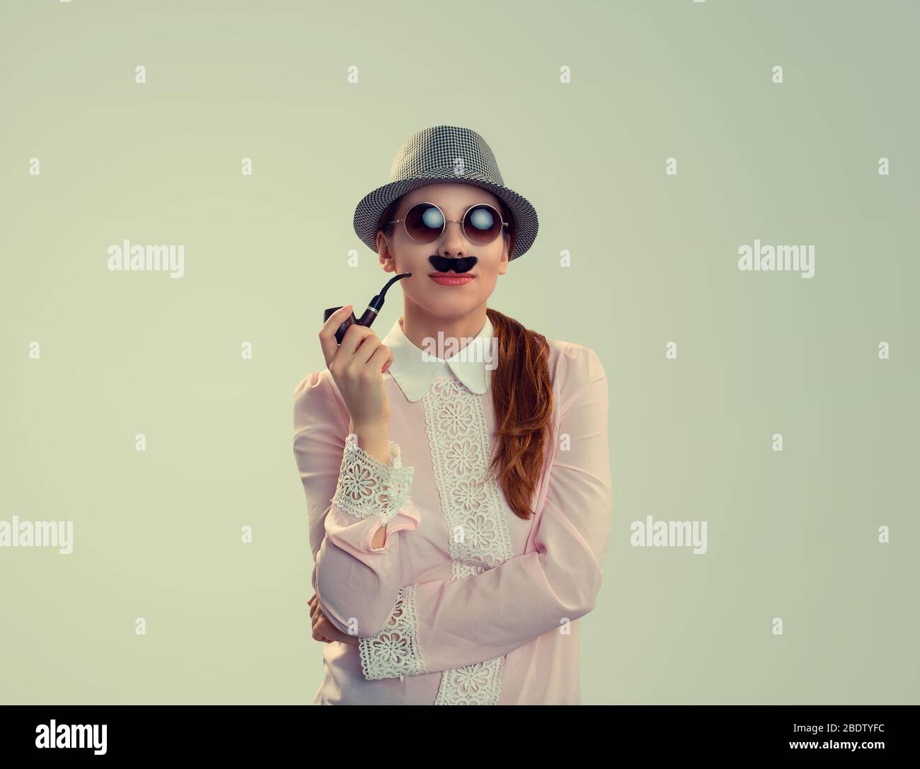 portrait of a pretty girl imitating a man Stock Photo - Alamy