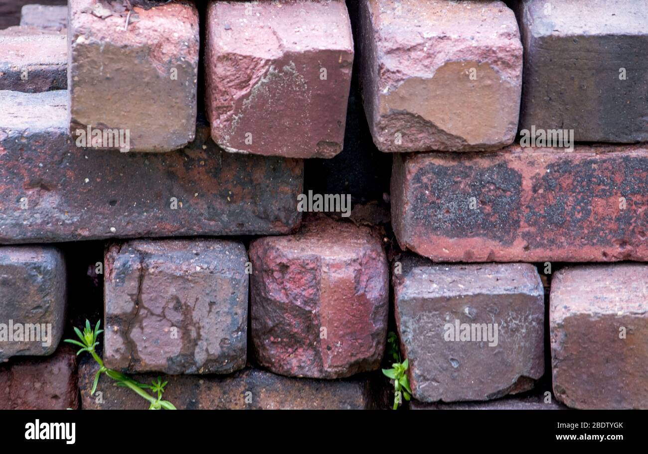 Old stacked bricks in a wall make a pretty patterns of textures and ...