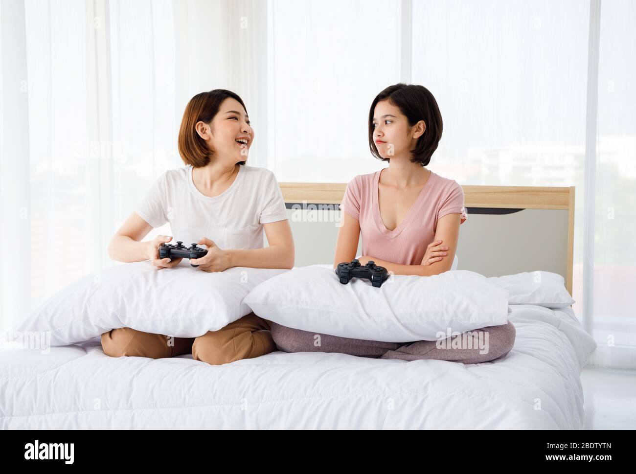 White shirt girl win the video game and taunt her friend who lose ...