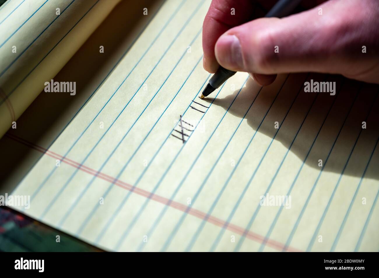 Caucasian hand using a pen to draw tally marks for counting Stock Photo ...