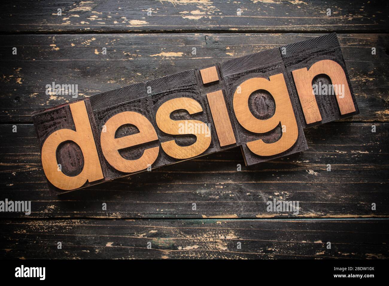 The word "DESIGN" written in vintage wood letterpress type on a vintage ...