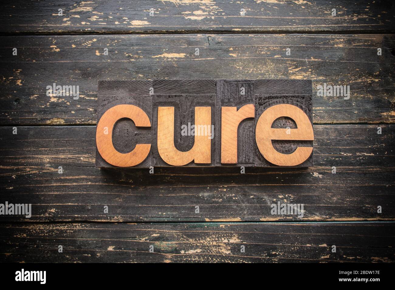 The word "CURE" written in vintage wood letterpress type on a vintage ...