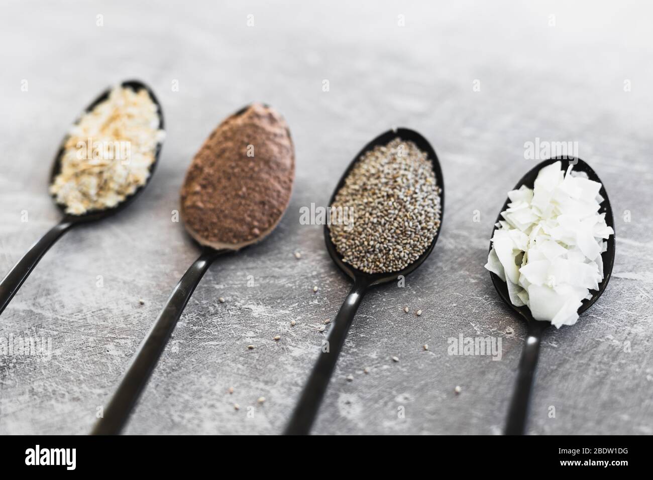 food ingredients for a healthy plant-based diet, spoons lined up on ...