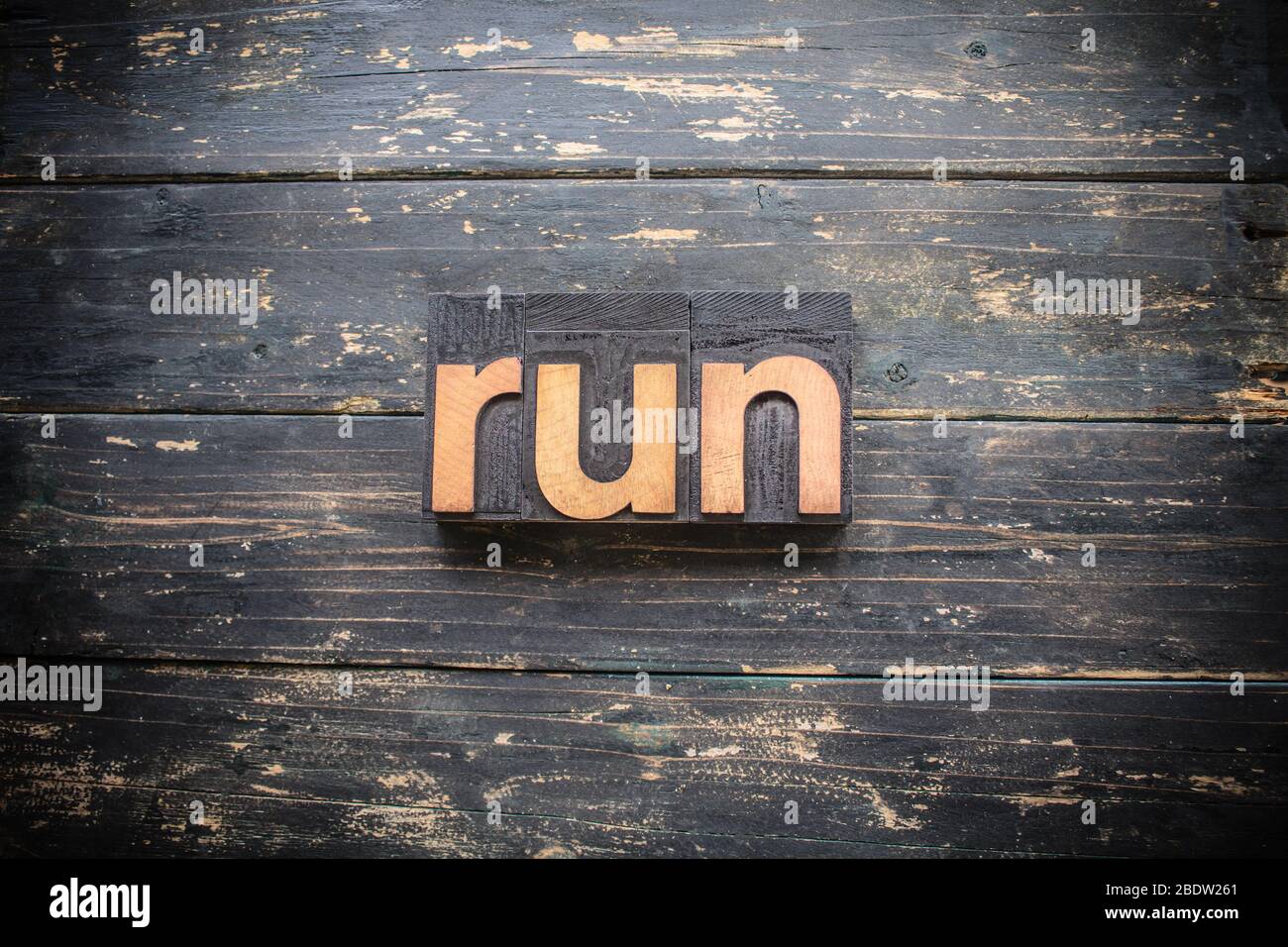 The word "RUN" written in vintage wood letterpress type on a vintage ...