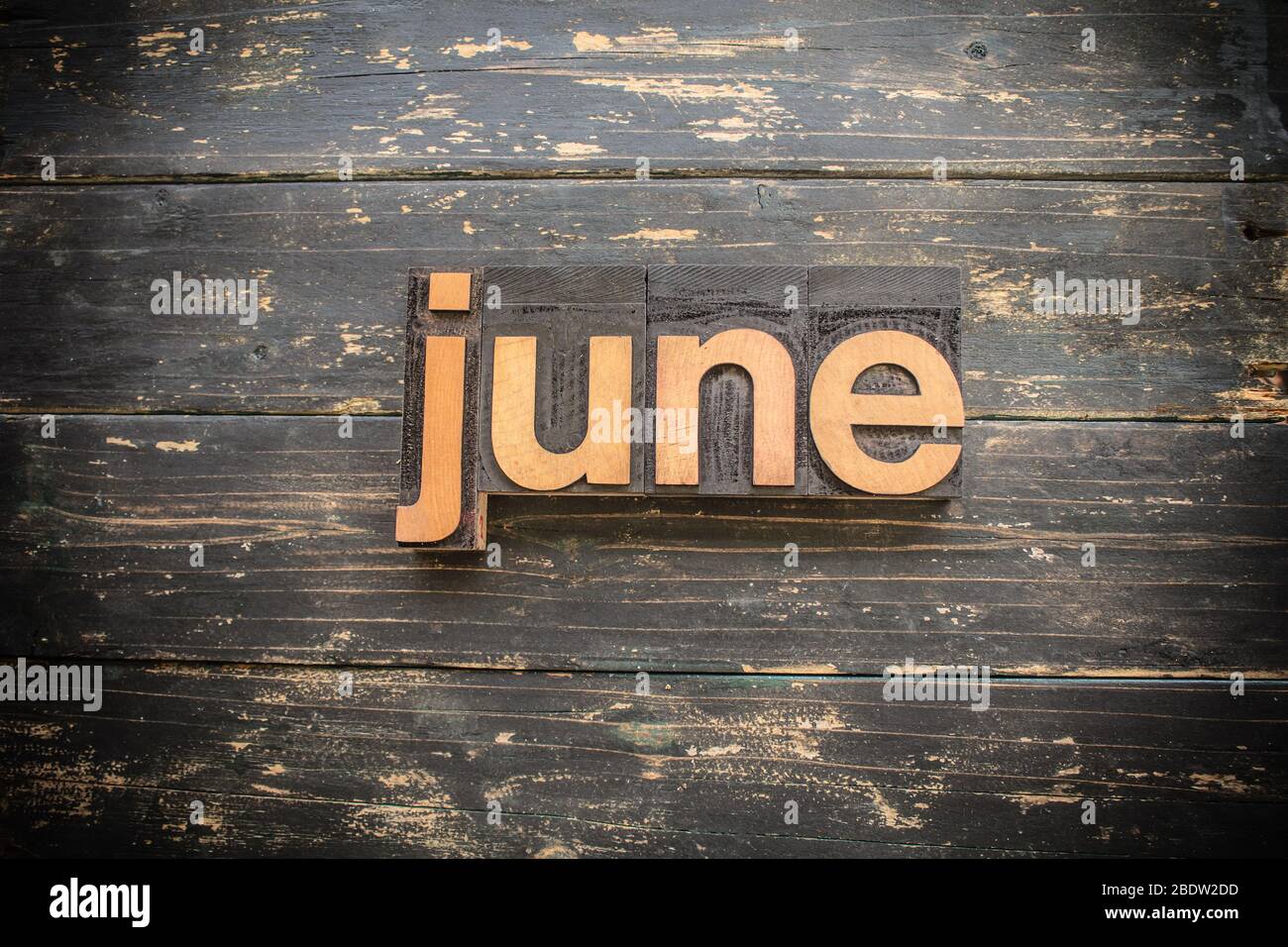 The word "JUNE" written in vintage wood letterpress type on a vintage ...
