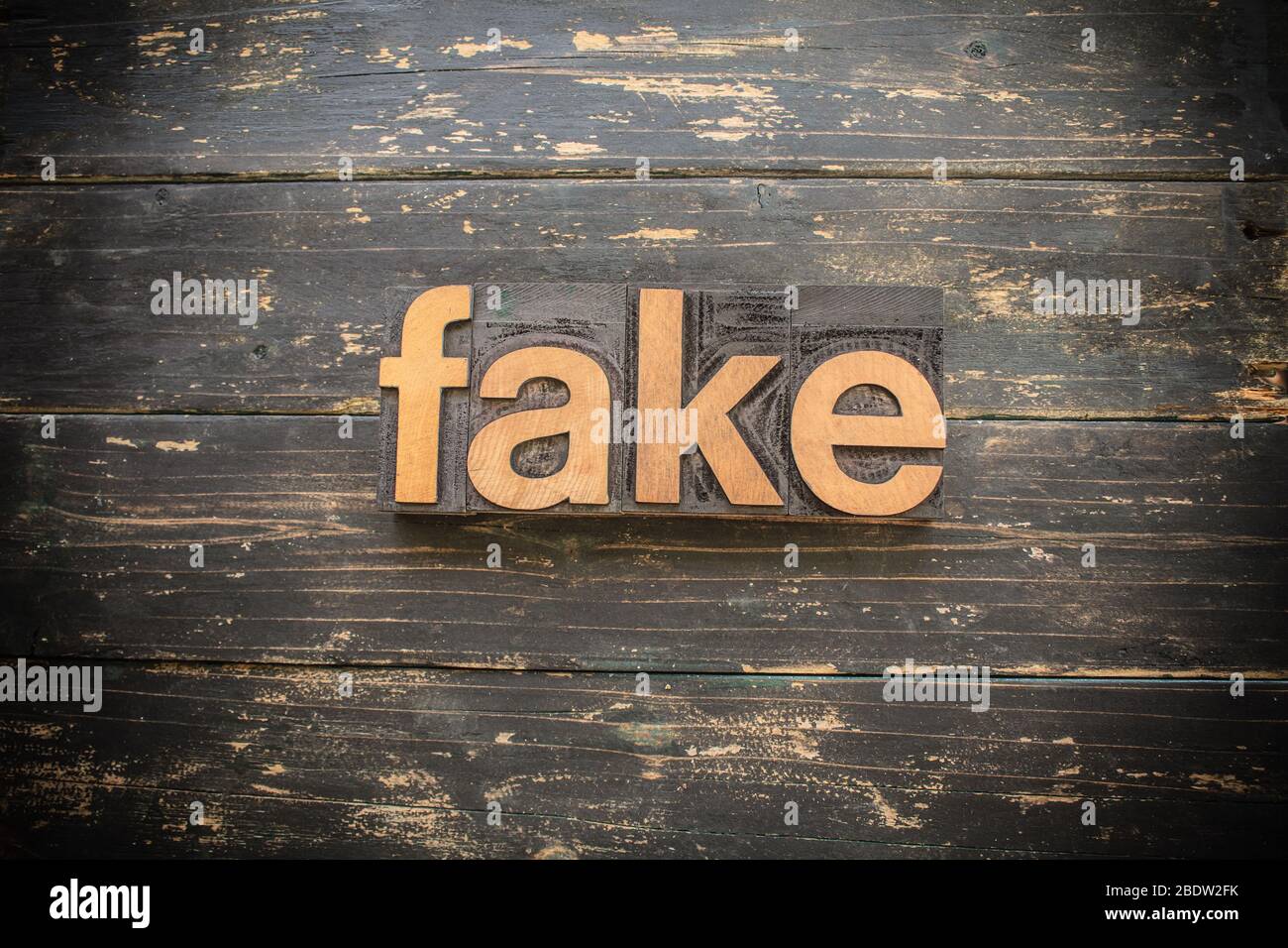 The word "FAKE" written in vintage wood letterpress type on a vintage ...