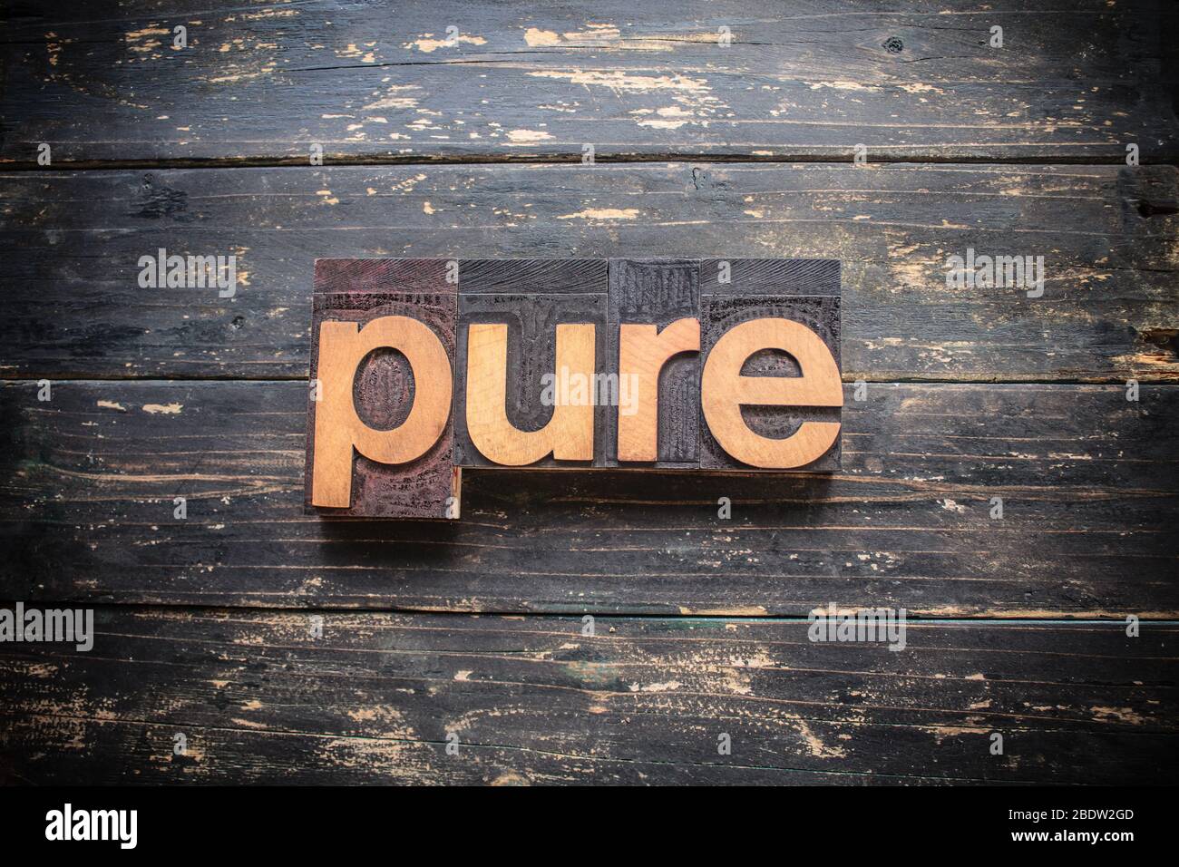 The word "PURE" written in vintage wood letterpress type on a vintage ...