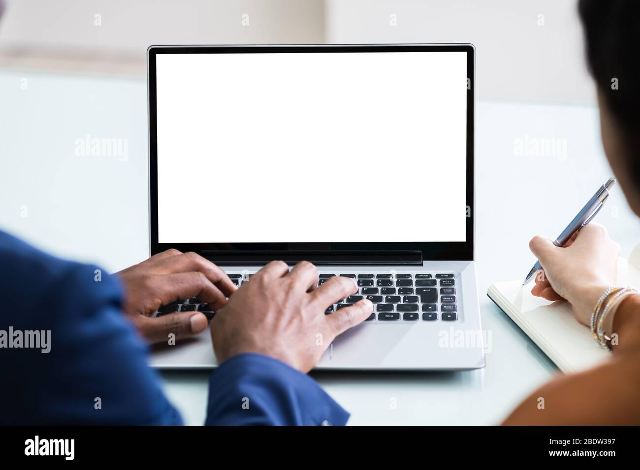 Two Businesspeople Working On Laptop With Empty Screen Stock Photo - Alamy