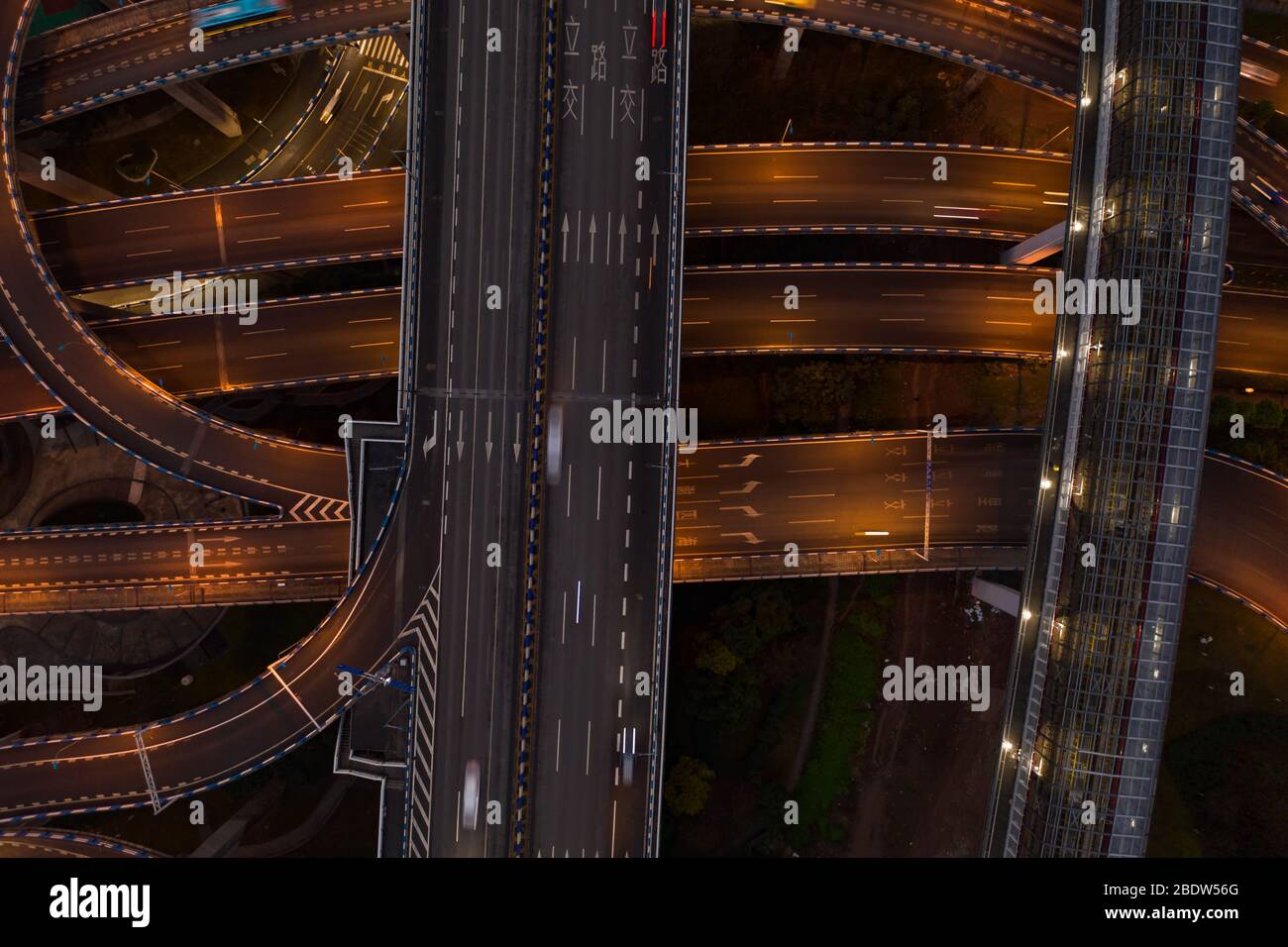 Aerial overhead shot of flyover highway traffic before dawn in ...