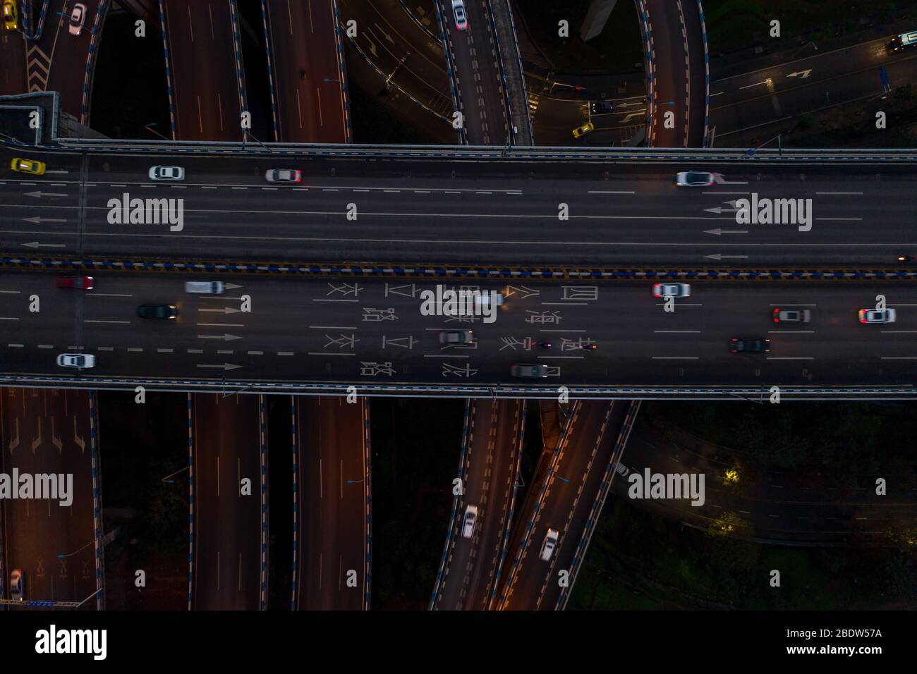 Aerial overhead shot of flyover highway traffic before dawn in ...