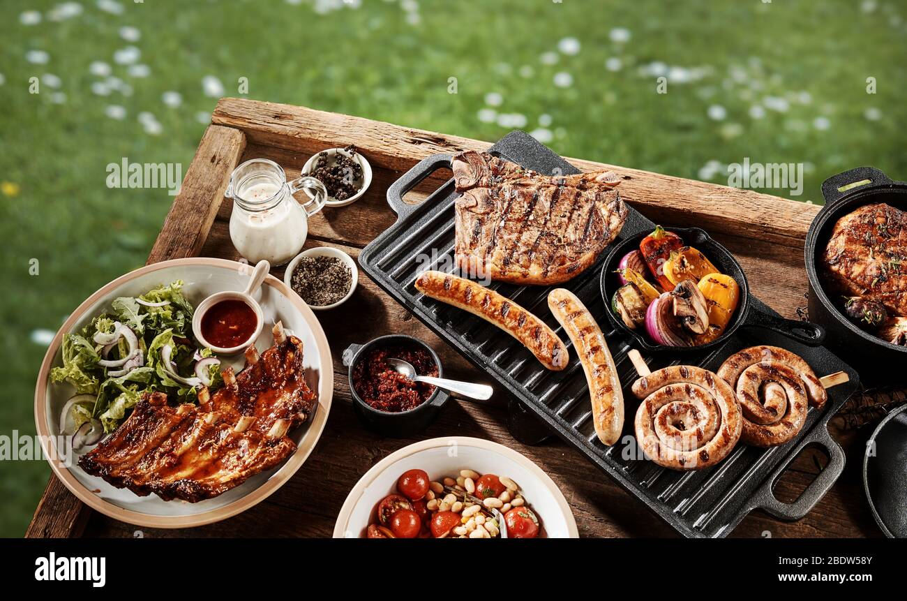 Assorted foods on a rustic timber table during a gourmet outdoor ...