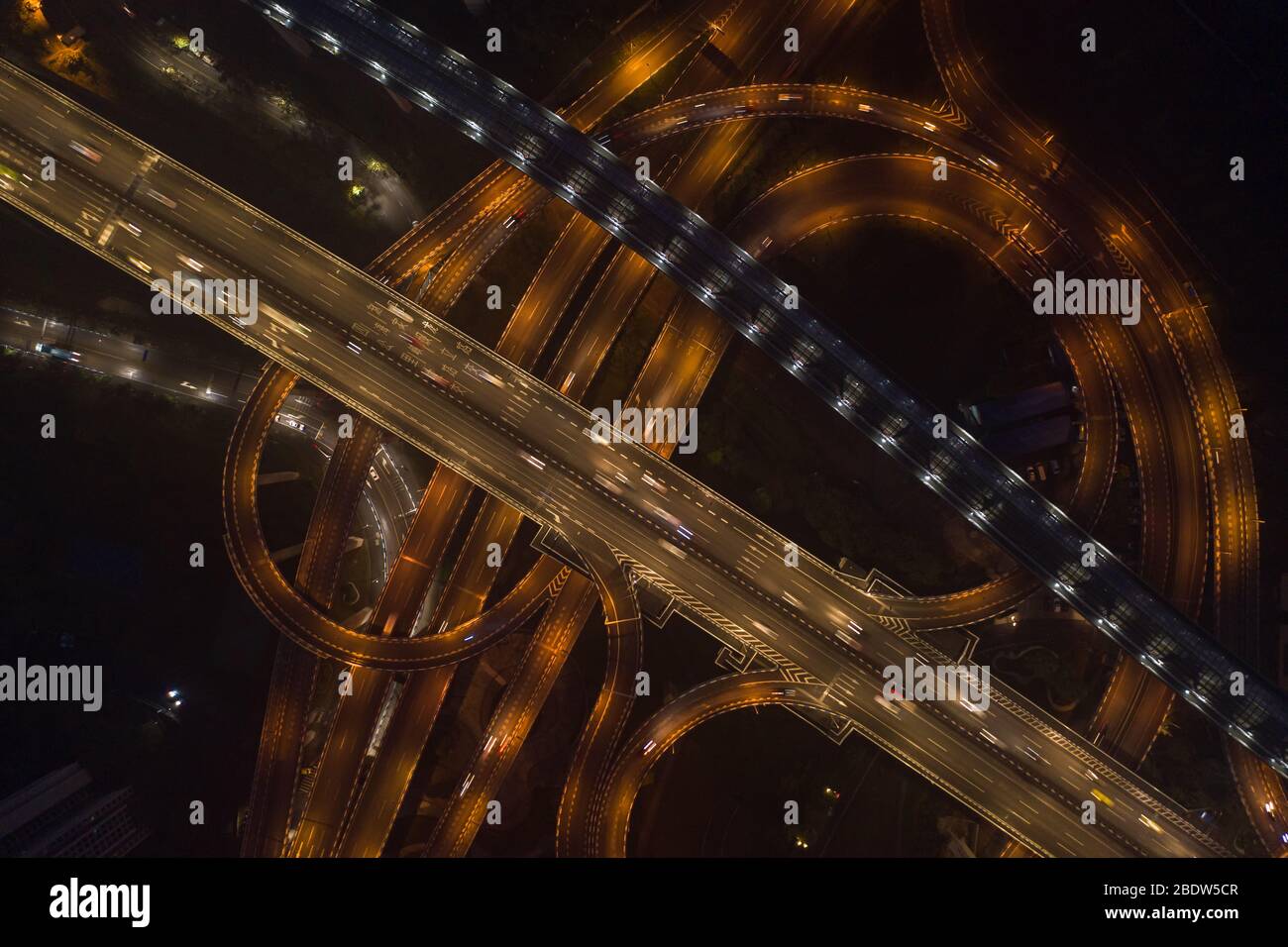 Aerial overhead shot of flyover highway traffic before dawn in ...