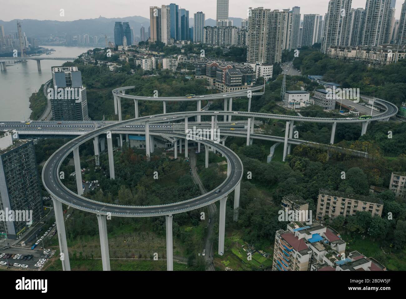 Aerial drone shot of gigantic flyover by Yangtze river in Caiyuanba ...