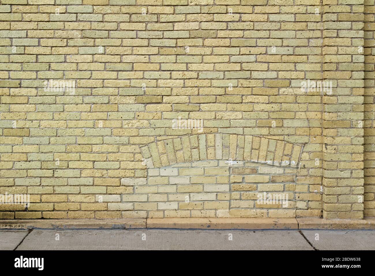 Shabby chic old yellow brick wall texture background, showing a pitted ...