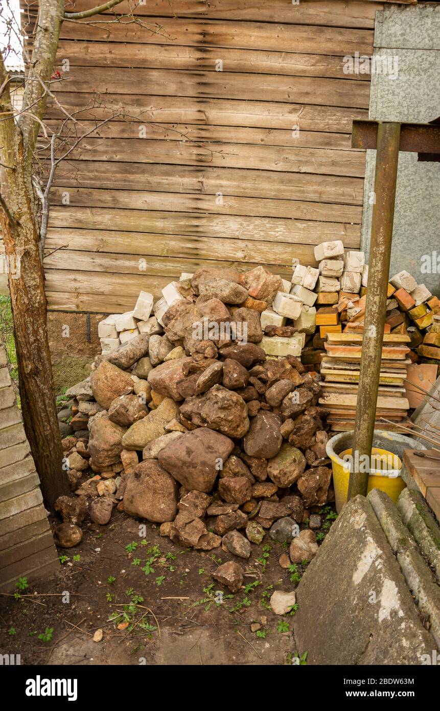 Stack of stones, various garden things, buckets Stock Photo - Alamy