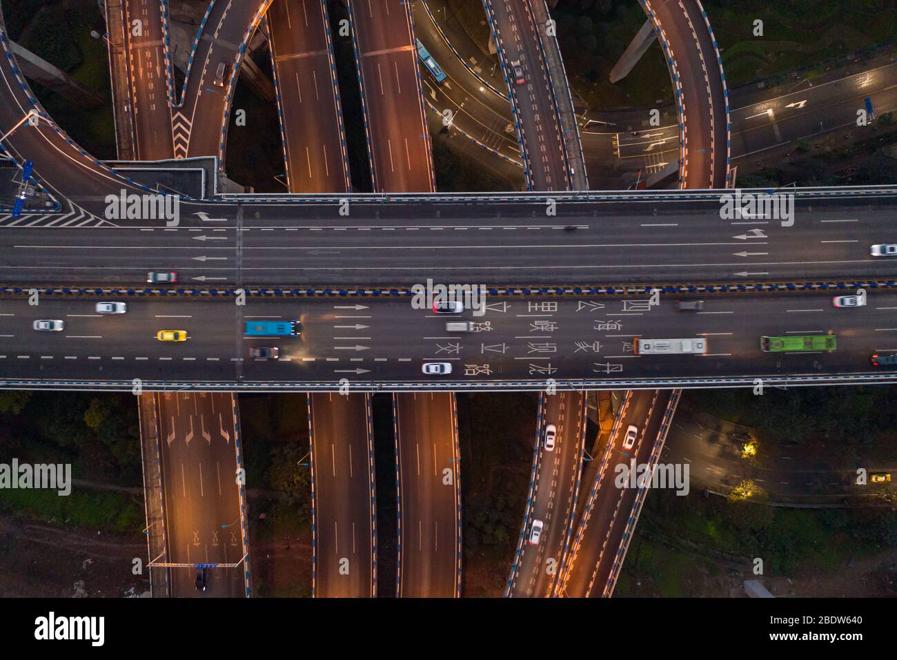 Aerial overhead shot of flyover highway traffic before dawn in ...