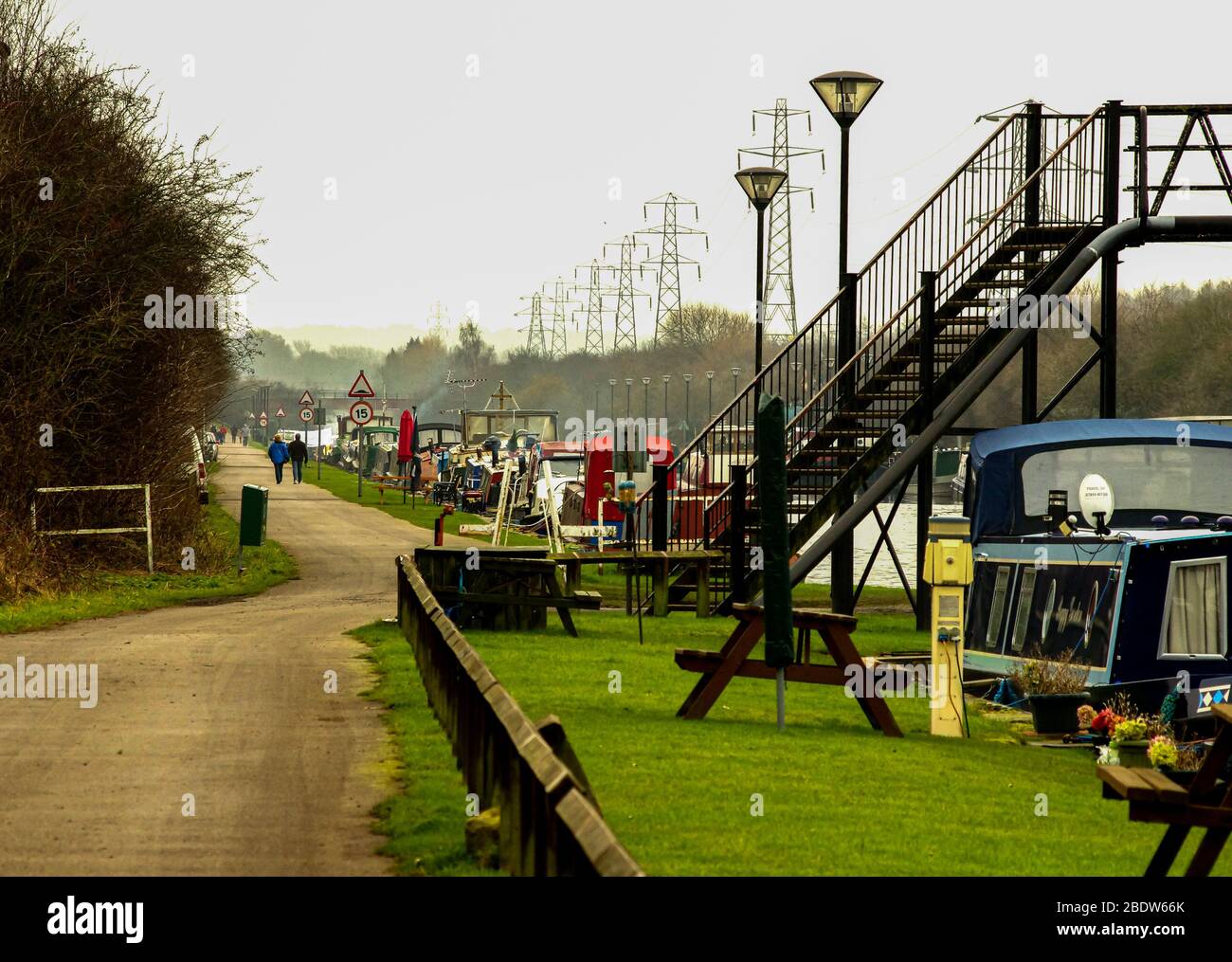 Ship in England river channel with footh paths Stock Photo - Alamy
