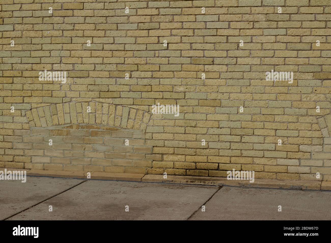 Shabby chic old yellow brick wall texture background, showing a pitted ...