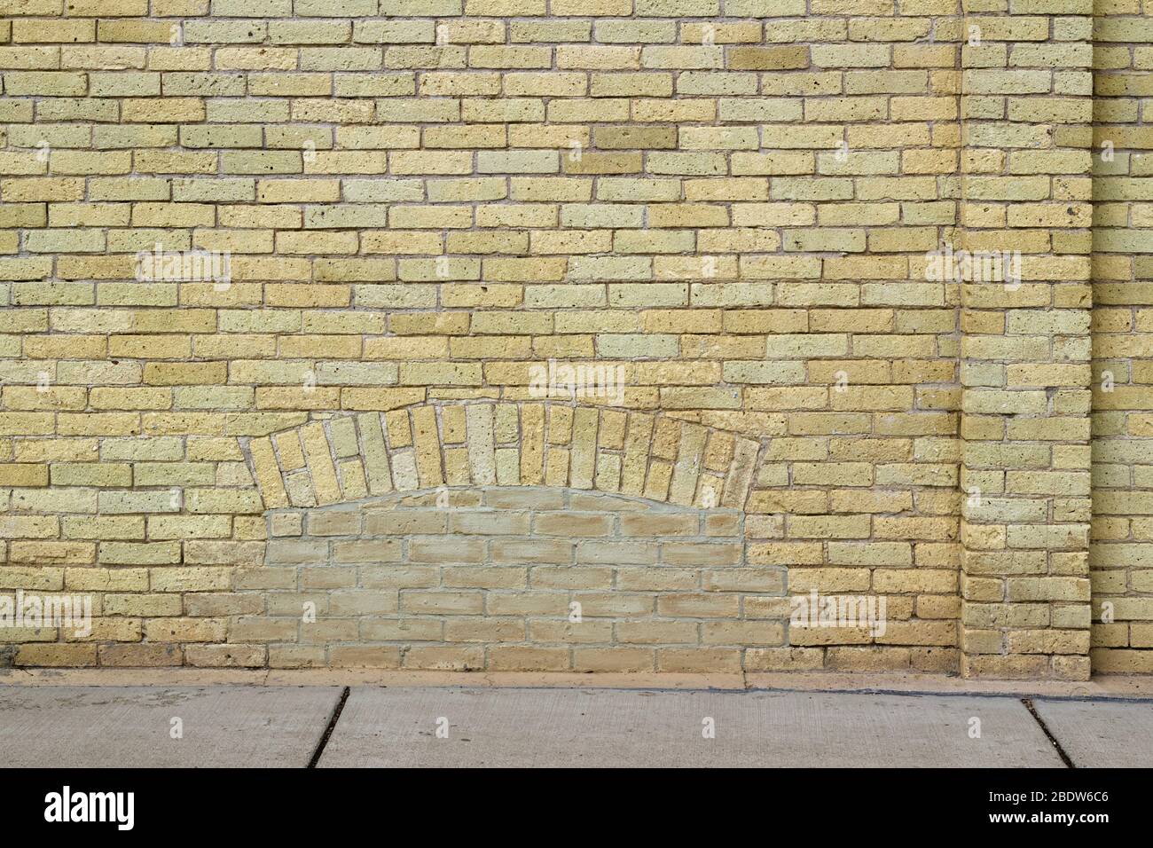 Shabby chic old yellow brick wall texture background, showing a pitted ...